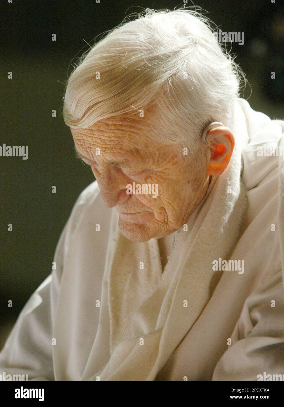Frere Roger, founder of the community of Taize, looks down during a ...