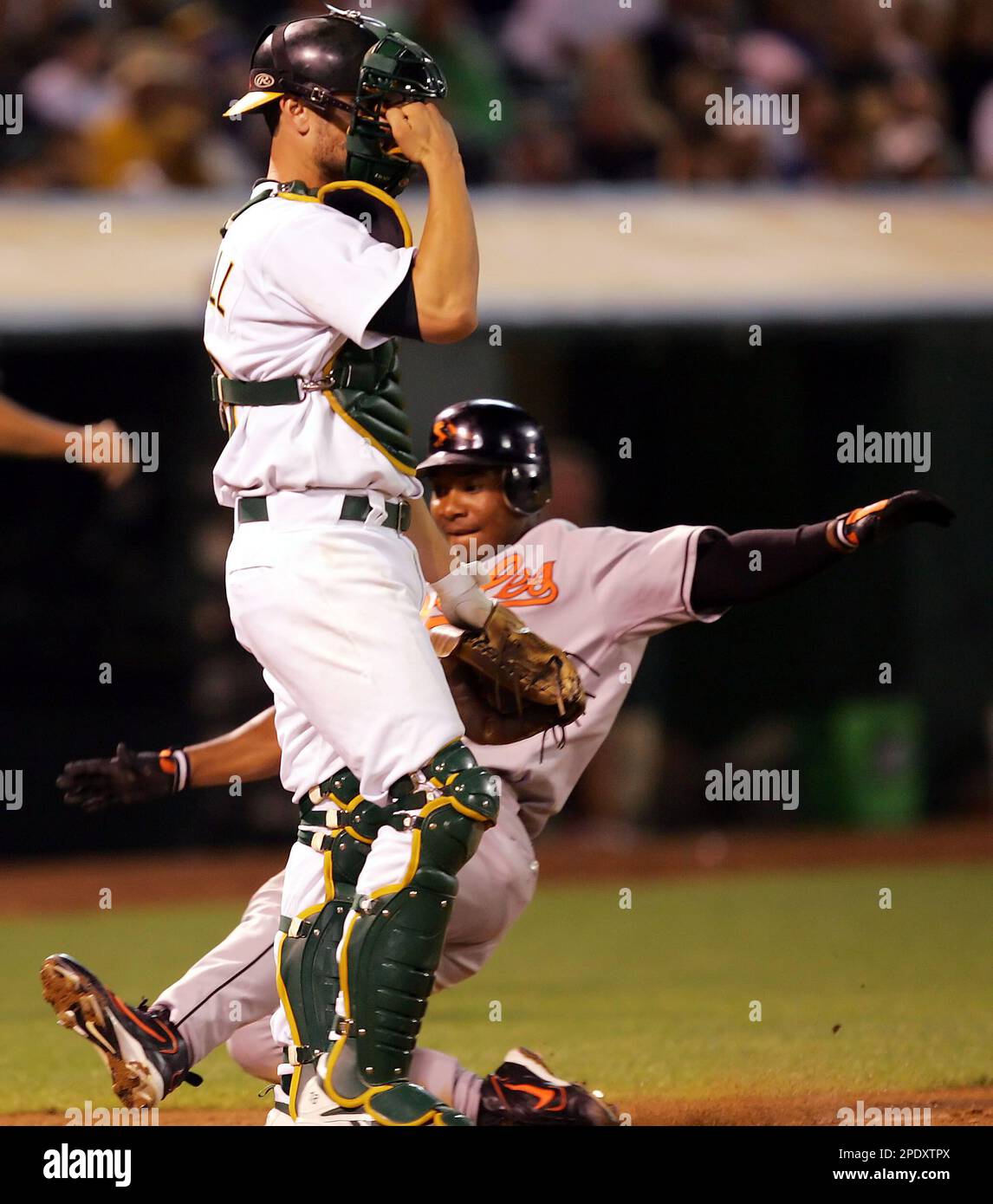Batimore Orioles' Melvin Mora, bottom, scores on a double by Miguel ...