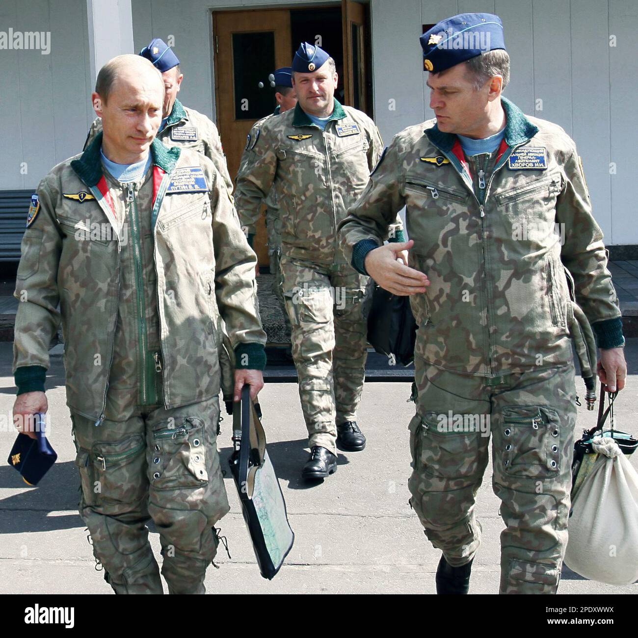 Russian President Vladimir Putin, left, wearing a jump suit heads with ...