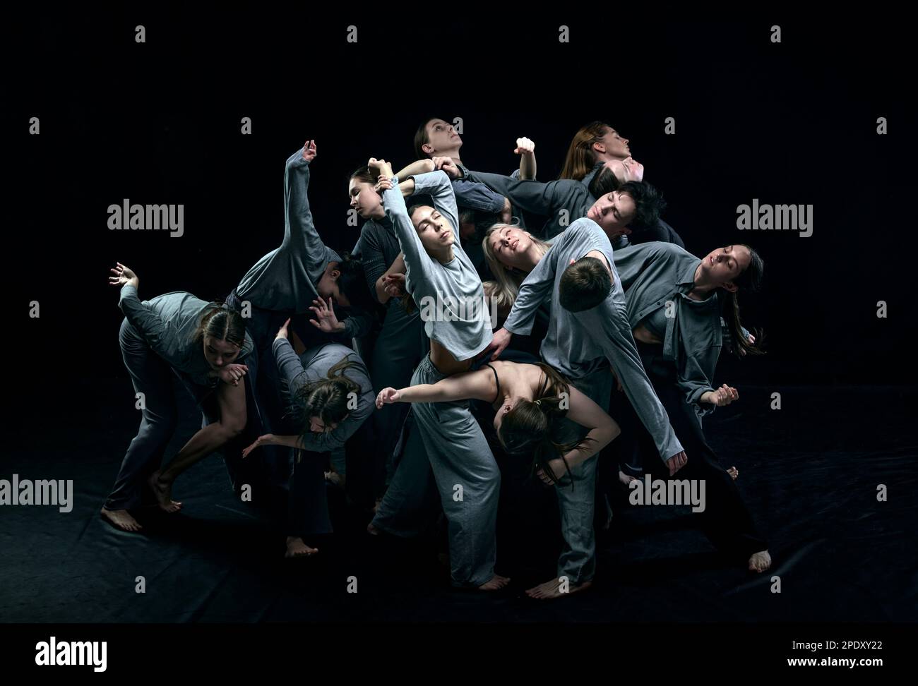 Group of young people in gray stage costumes making performance ...