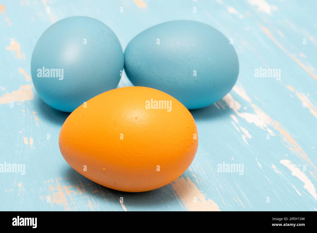 Eggs symbolizing the Easter holiday in blue and orange color on a ...