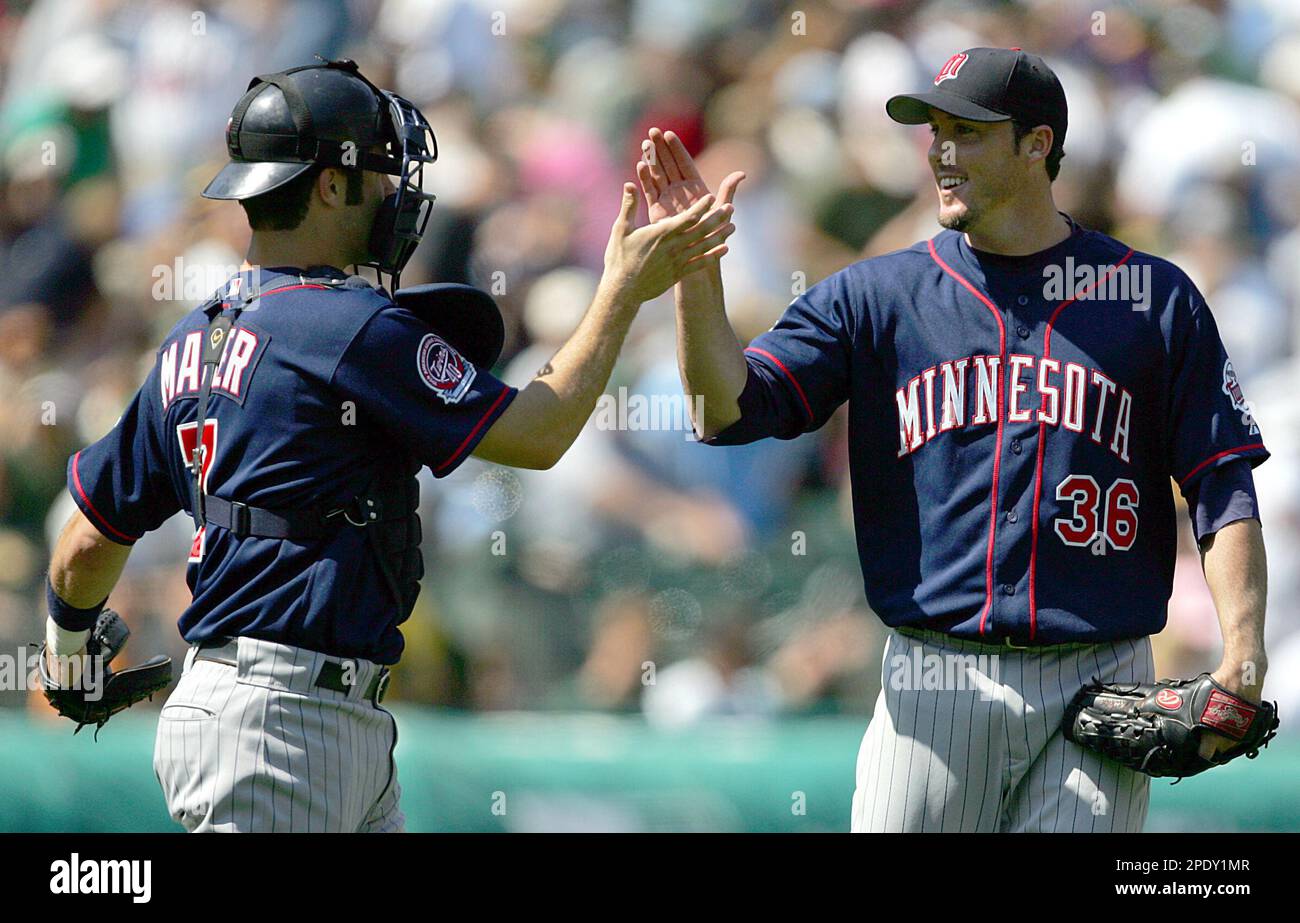 Minnesota Twins catcher Joe Mauer, left, congratulates pitcher Joe ...