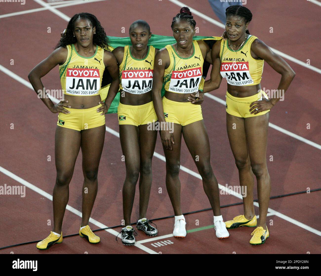 Members of the Jamaican Women's 4x400 meters relay team wave to the ...