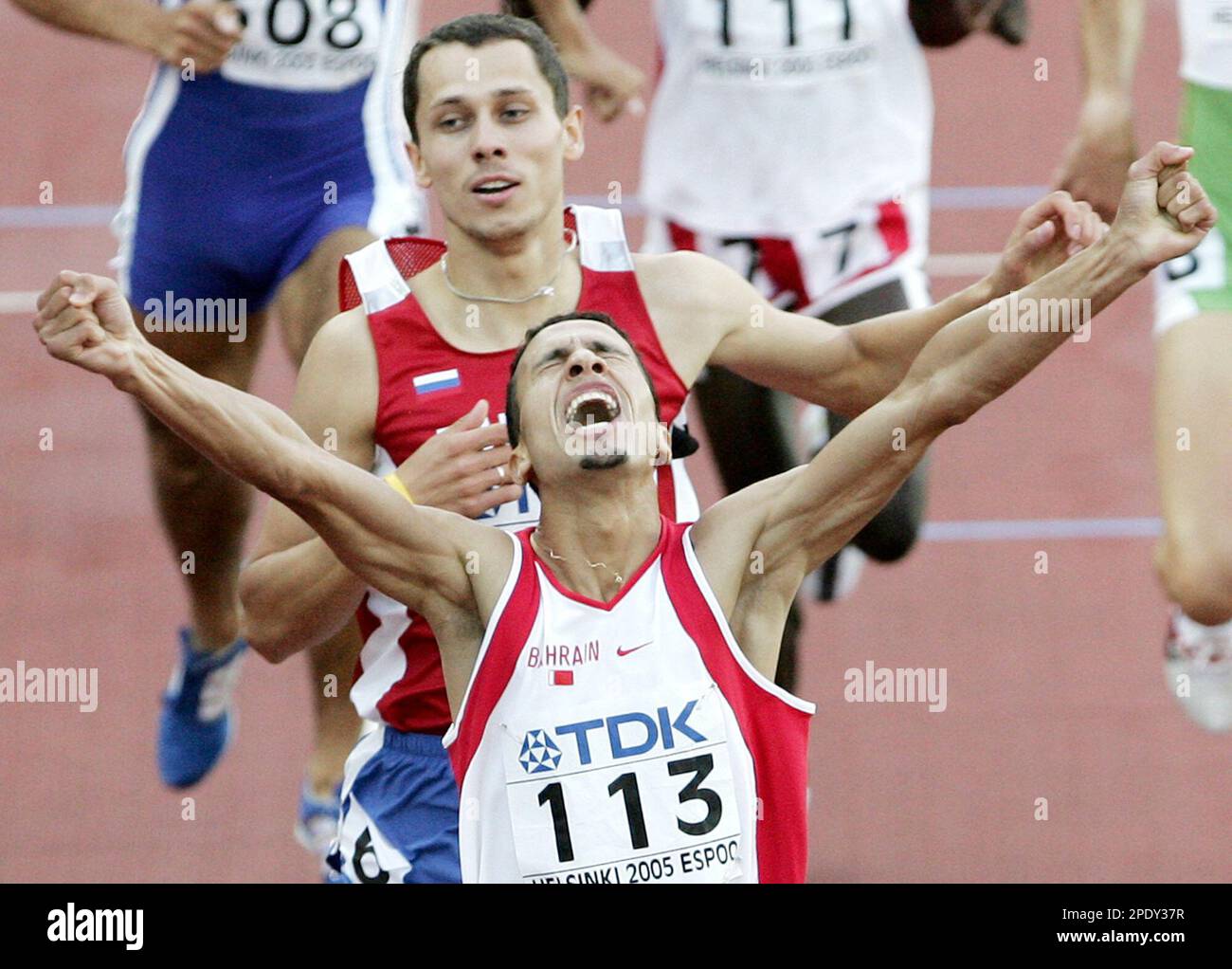 Bahrain's Rashid Ramzi reacts as he crosses the line ahead of Russia's ...