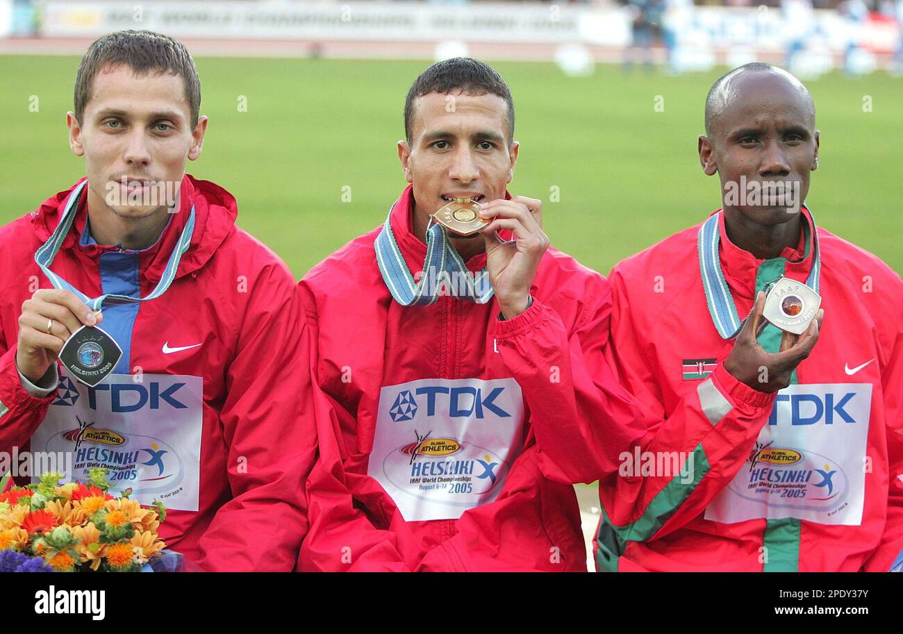 Bahrain's Rashid Ramzi, center, poses with the gold medal he won in the ...