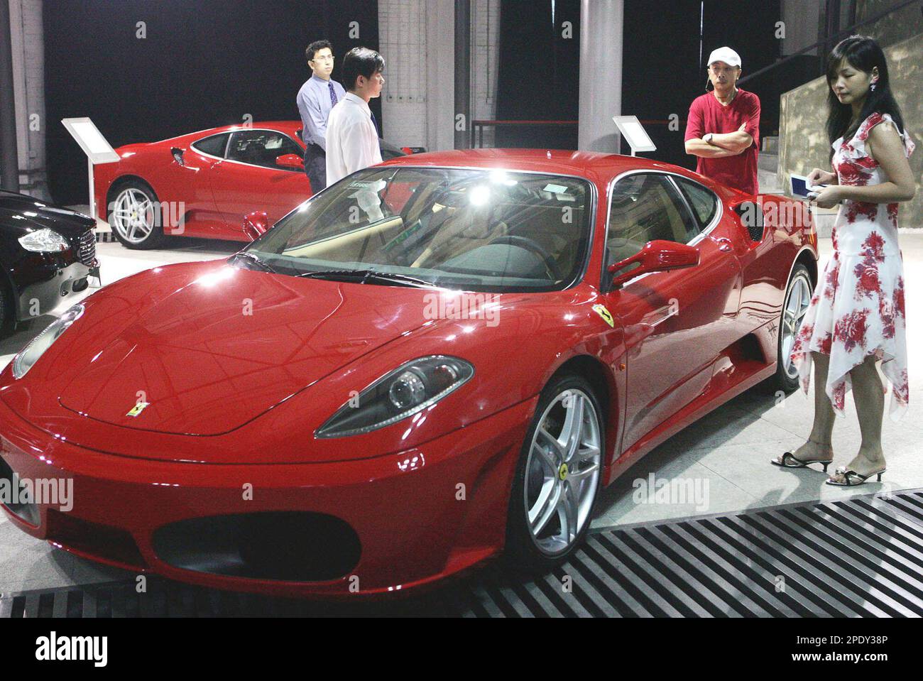 Chinese visitors at the Beijing Jundong Cars Services show room where ...