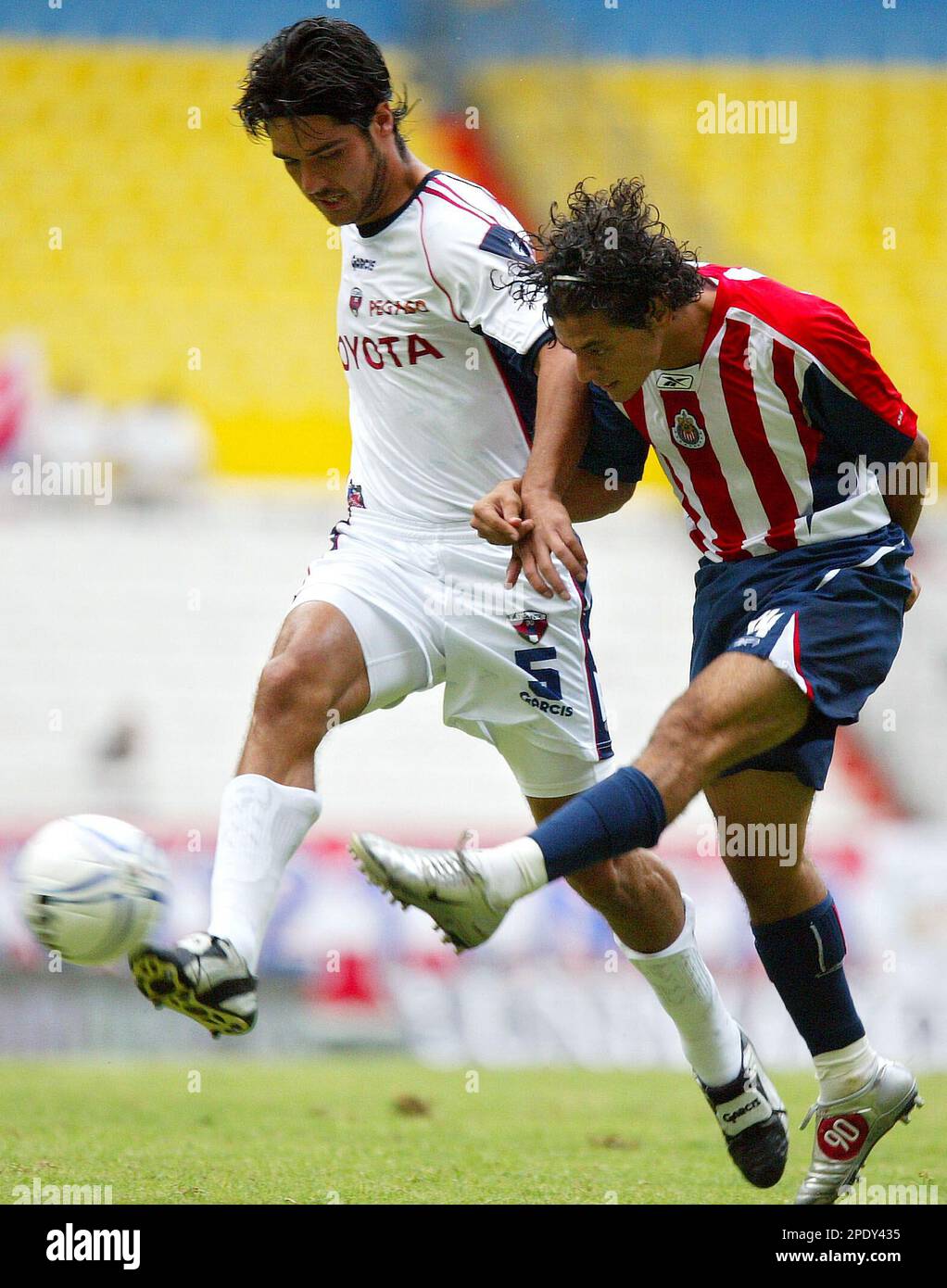 Chivas player Alejandro Vela, right, fights for the ball with Atlante`s ...