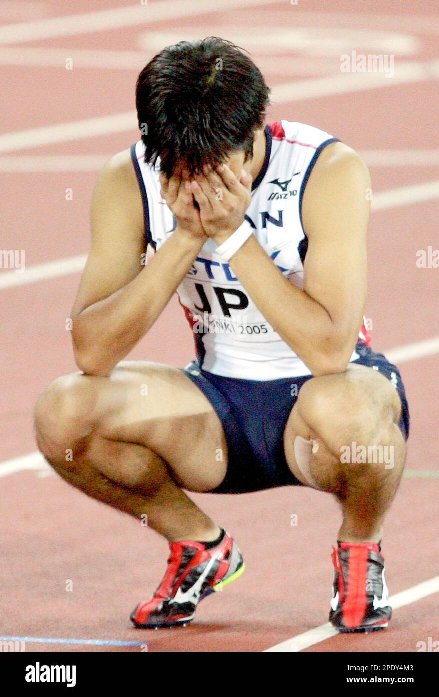 A member of the Japanese relay team reacts after they took the eigth ...