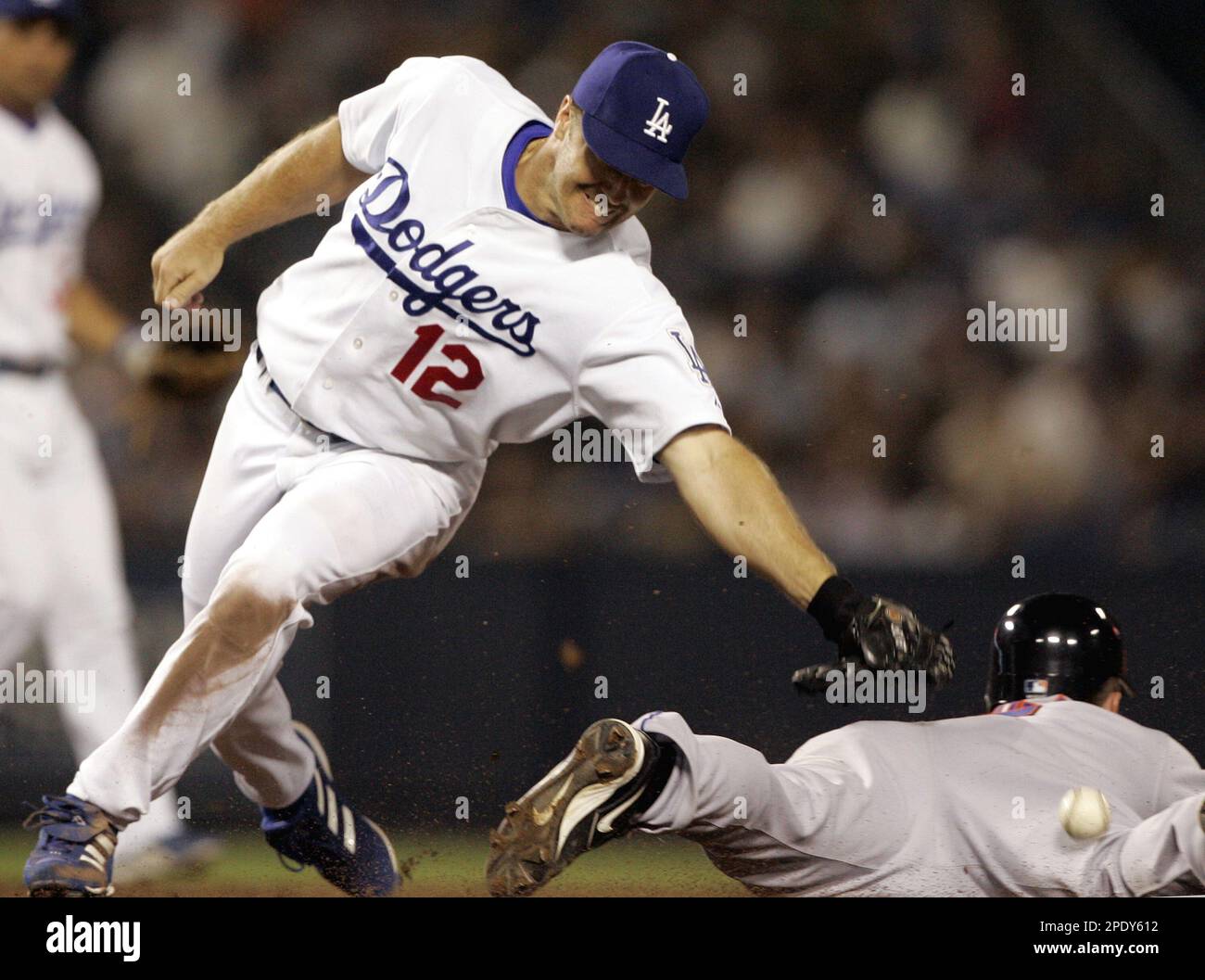 Los Angeles Dodgers' Jeff Kent, left, misses the throw from the catcher ...