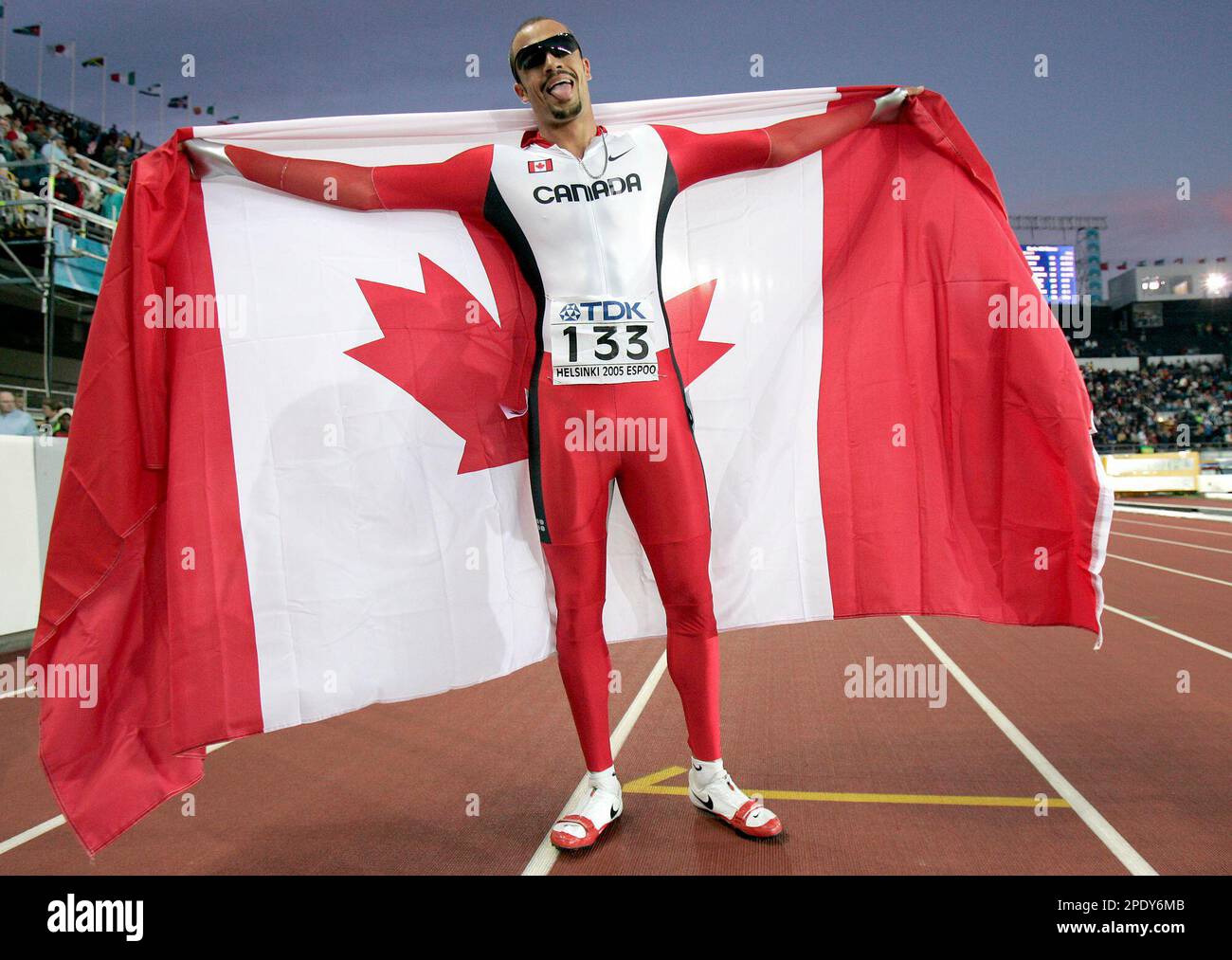 Canada's Christopher Tyler poses with his national flag after finishing ...