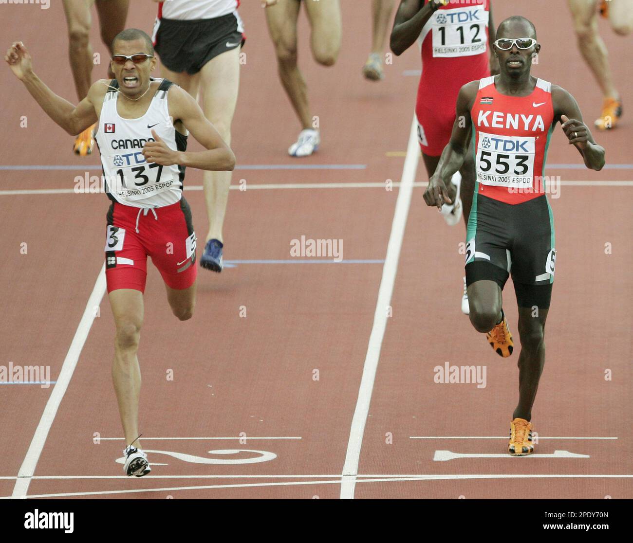 Canada's Gary Reed, left, crosses the line ahead of Kenya's Wilfred ...