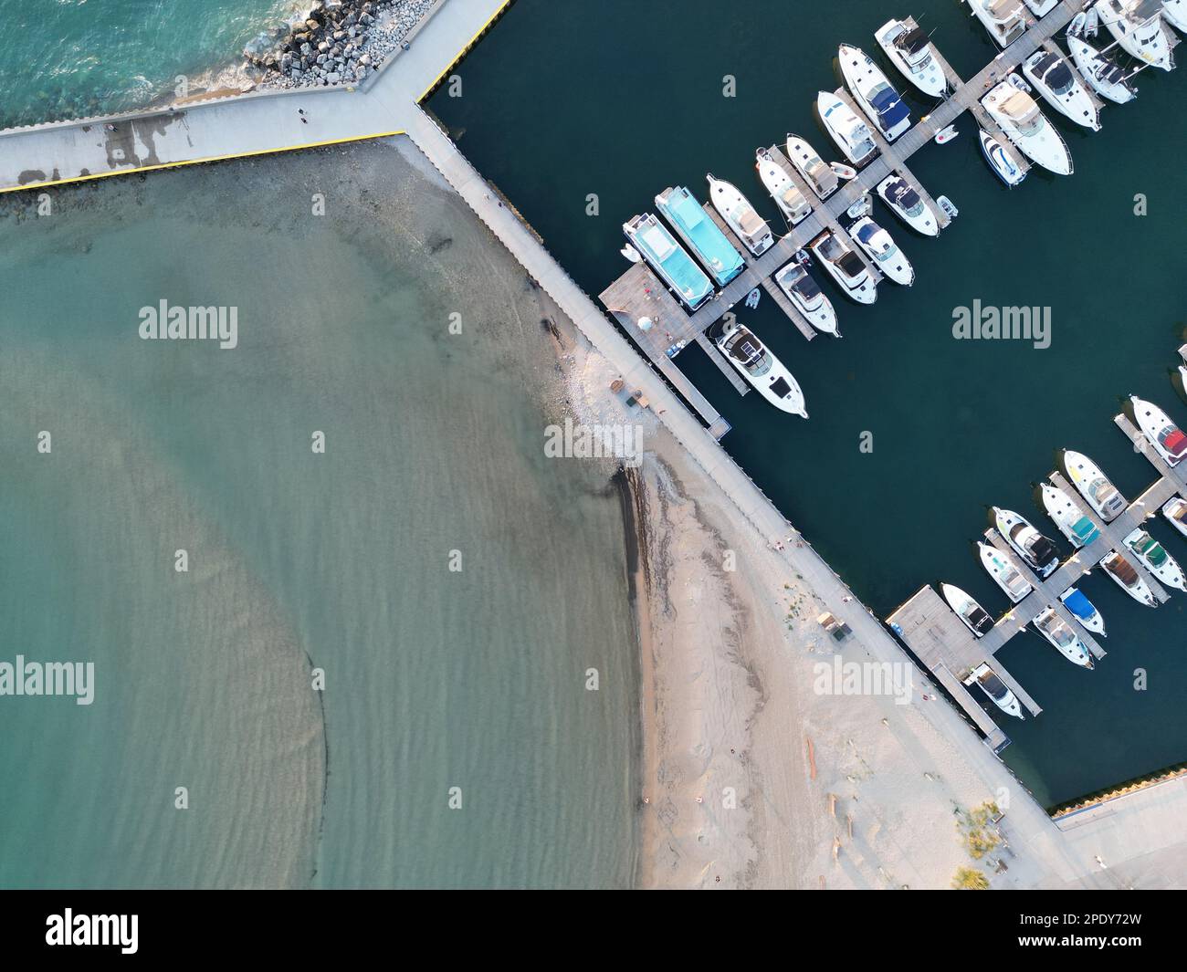 An expansive boat dock filled with a variety of vessels, stretching ...
