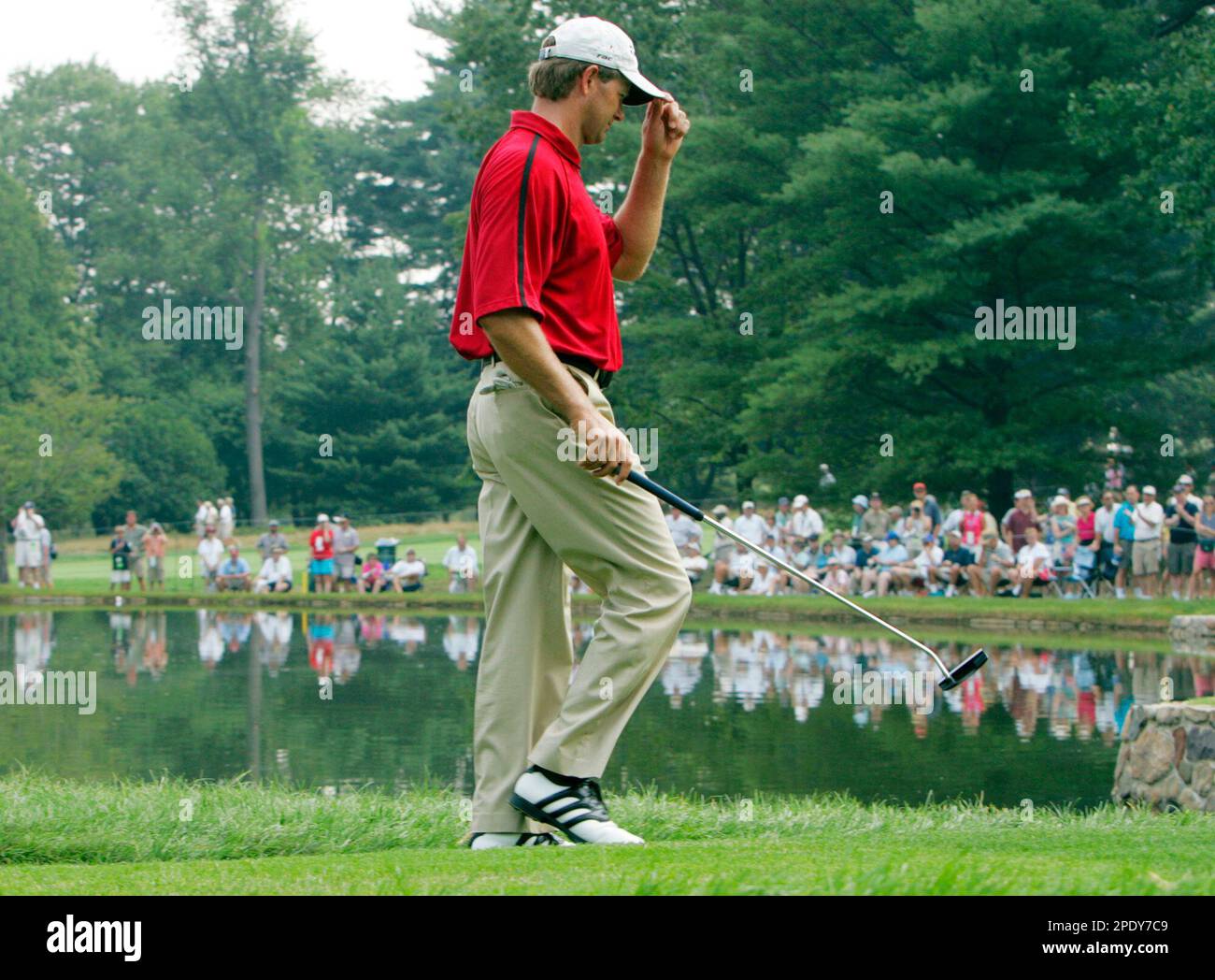 Retief Goosen, of South Africa, tips his cap walking to the fourth ...