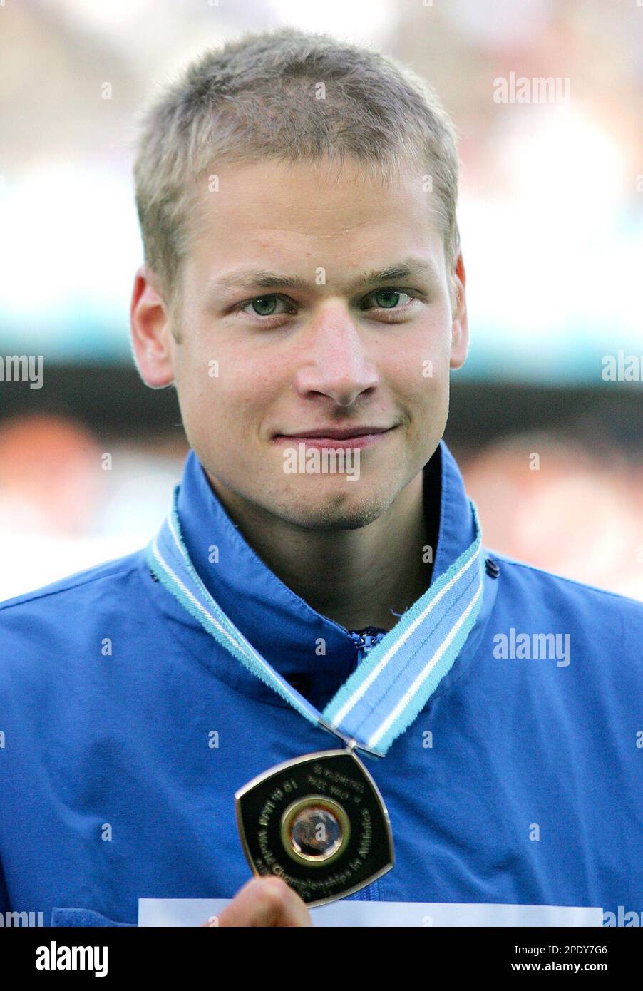 Alex Schwazer of Italy displays the bronze medal he won in the 50 ...