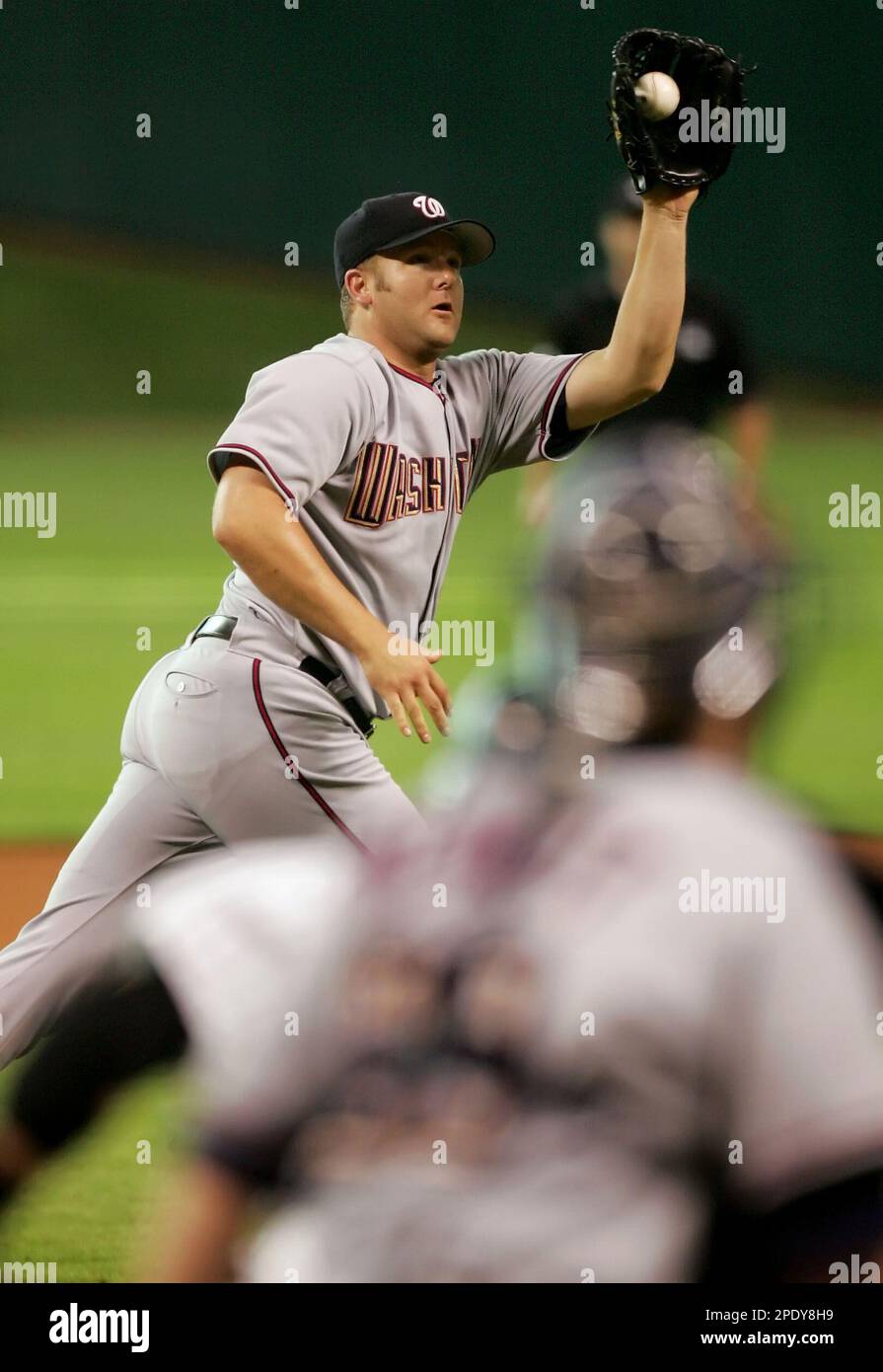 Washington Nationals pitcher Ryan Drese fields a ball hit by Houston ...