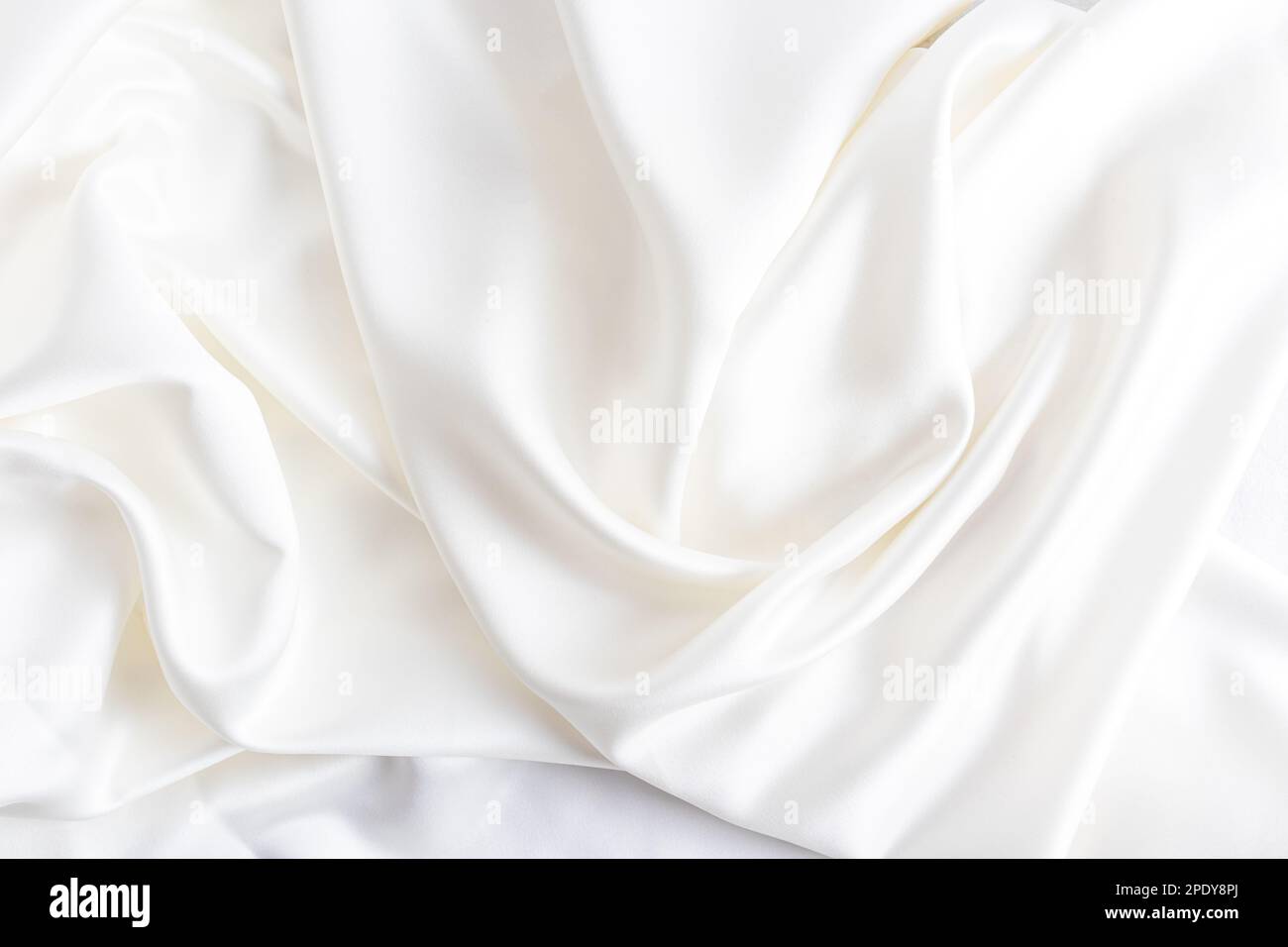 luxury wedding textiles. satin beige delicate background. soft waves of ...