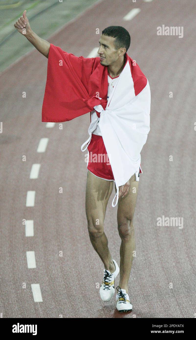 Rashid Ramzi of Bahrain salutes the crowd, after he won the gold medal ...