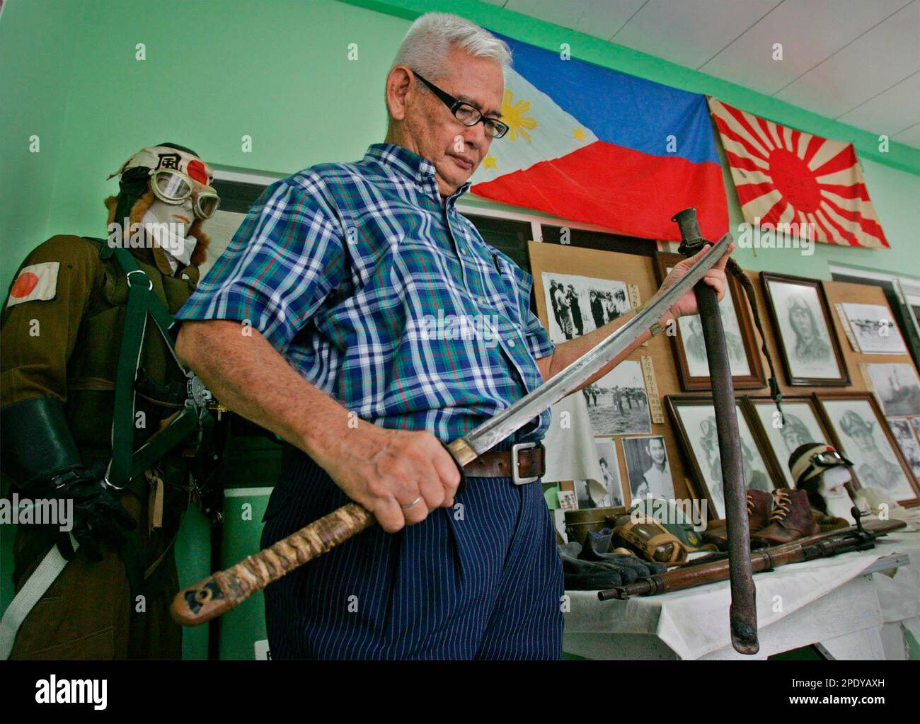 Local historian, Daniel Dizon, checks the condition of a Japanese Samurai (sword), one of ...