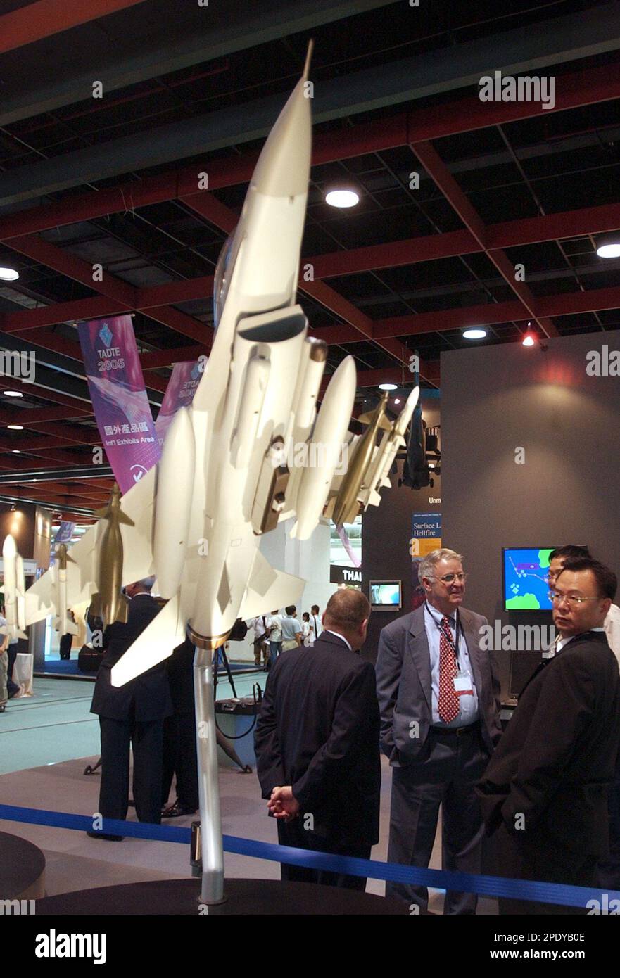 Visitors take a look at a model of a U.S.-made F-16 jet fighter ...