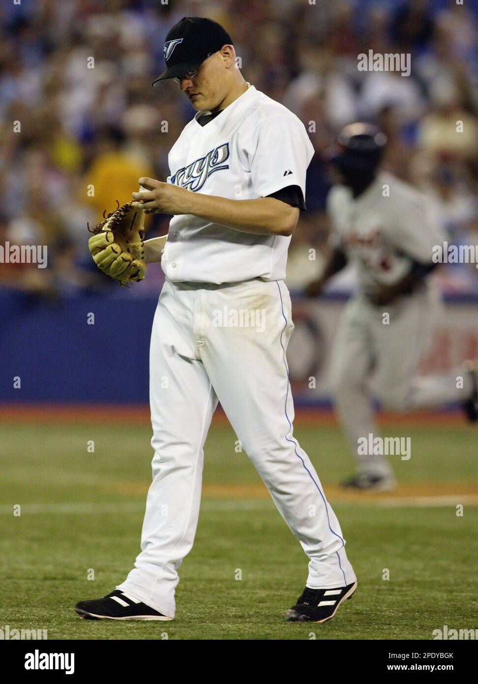 Toronto Blue Jays starting pitcher Gustavo Chacin looks at the ball as ...