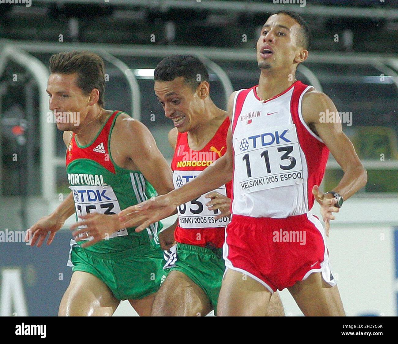 Rashid Ramzi of Bahrain, right, reacts as he crosses the finish line to ...