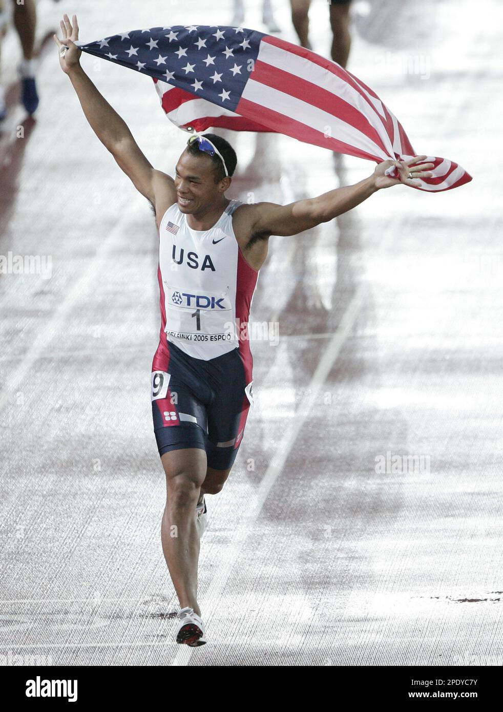 Bryan Clay of the US celebrates with the Stars and Stripes, after ...
