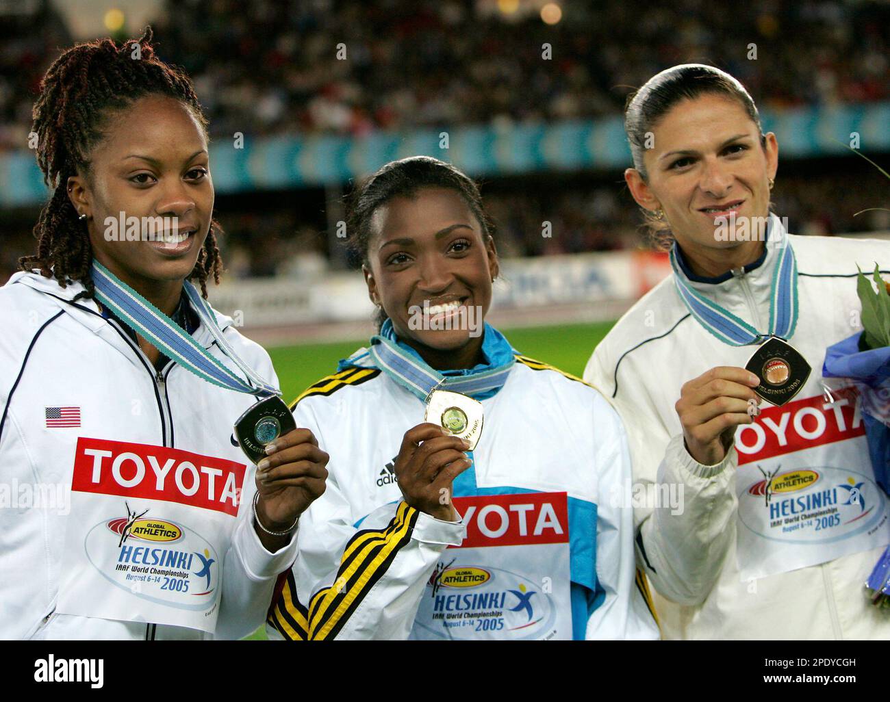 Tonique Williams-Darling of the Bahamas, center, shows her gold medal ...