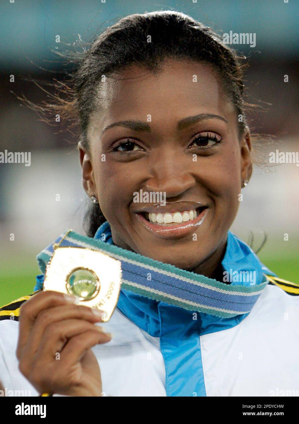 Tonique Williams-Darling of the Bahamas shows her gold medal follwoing ...
