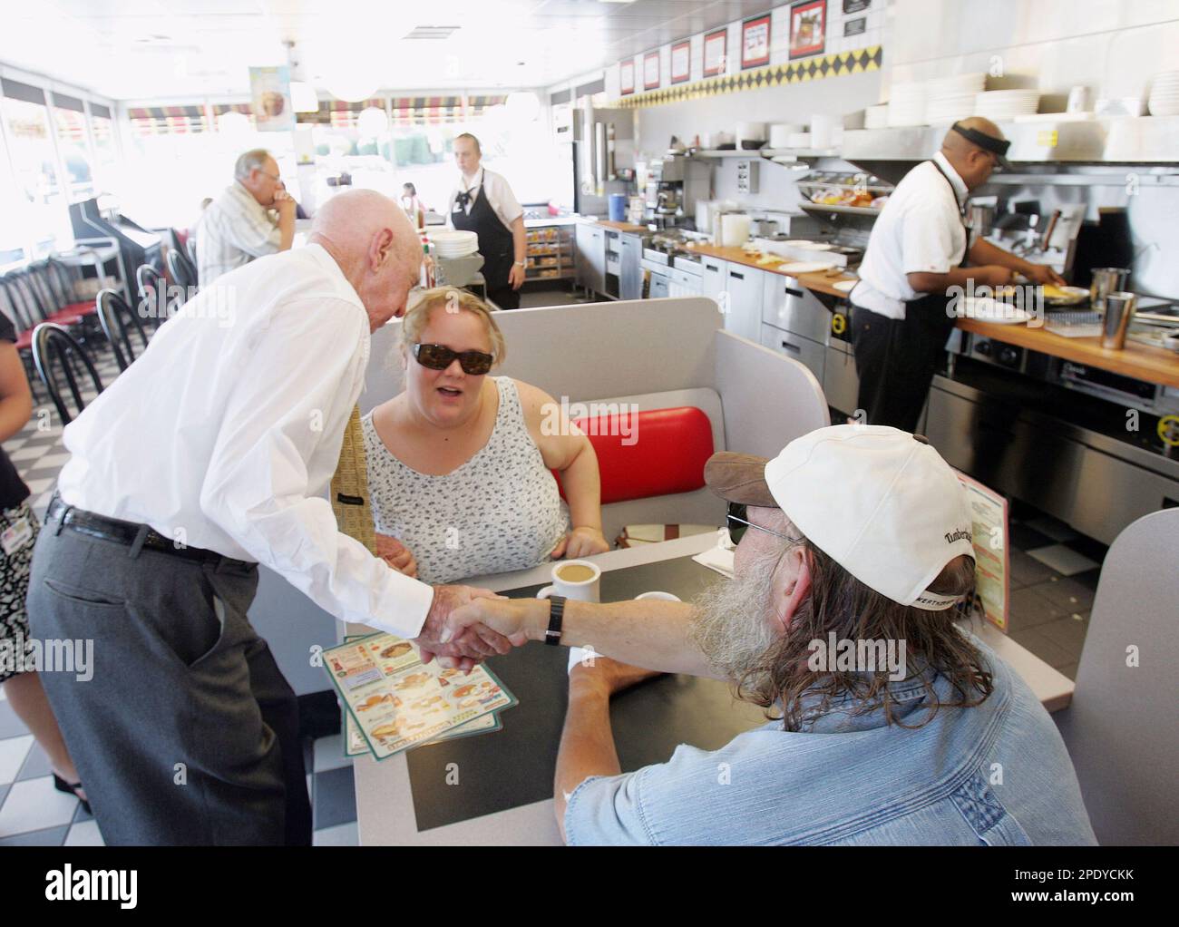 Waffle House founder Joe Rogers, Sr., left, greets long time customers ...