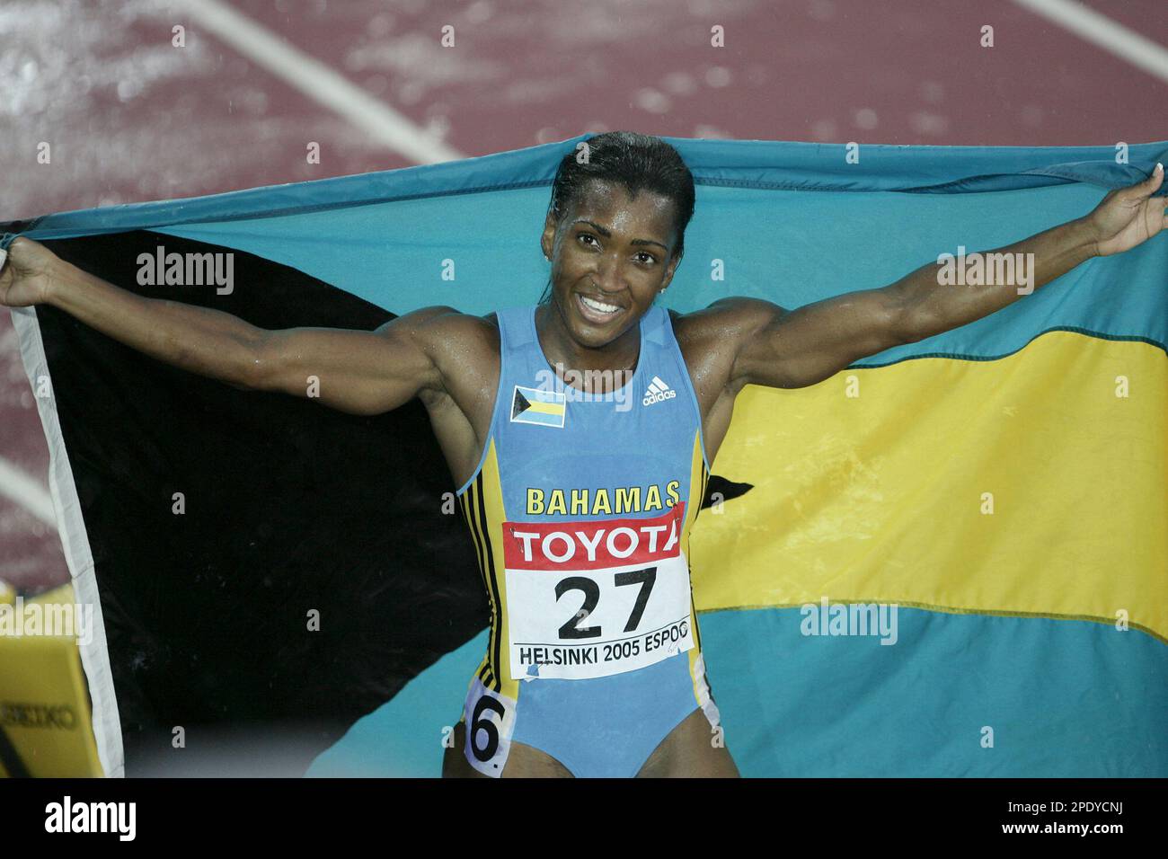 Tonique Williams-Darling of the Bahamas holds her nation's flag in the ...