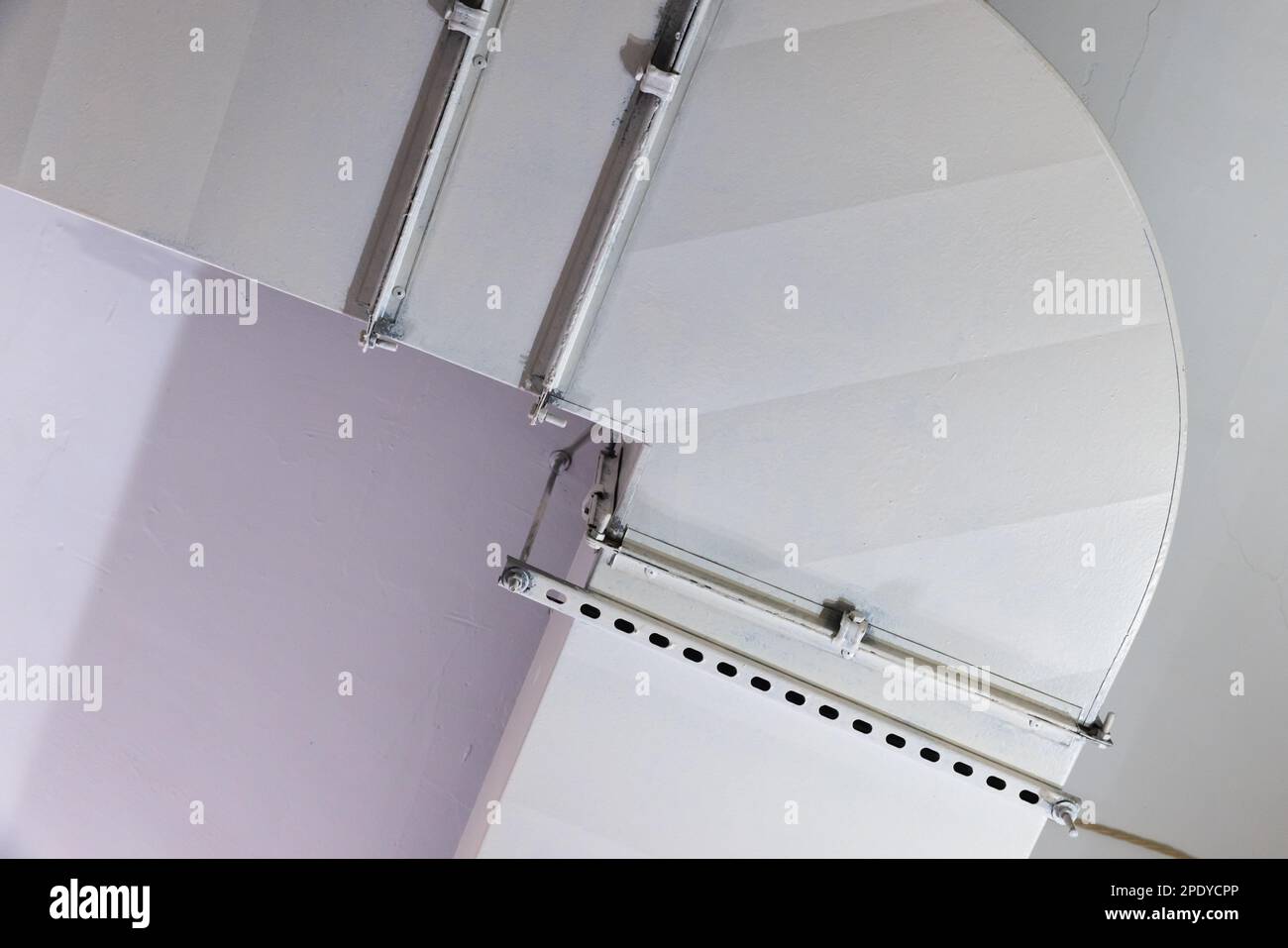 Bending ventilation duct mounted under the ceiling in an industrial ...