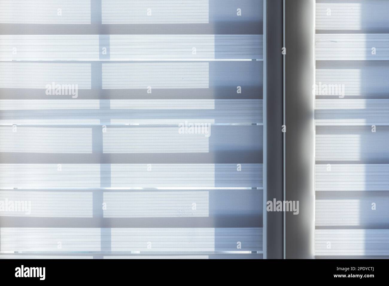 Textile translucent blinds on a window on a sunny day, abstract ...