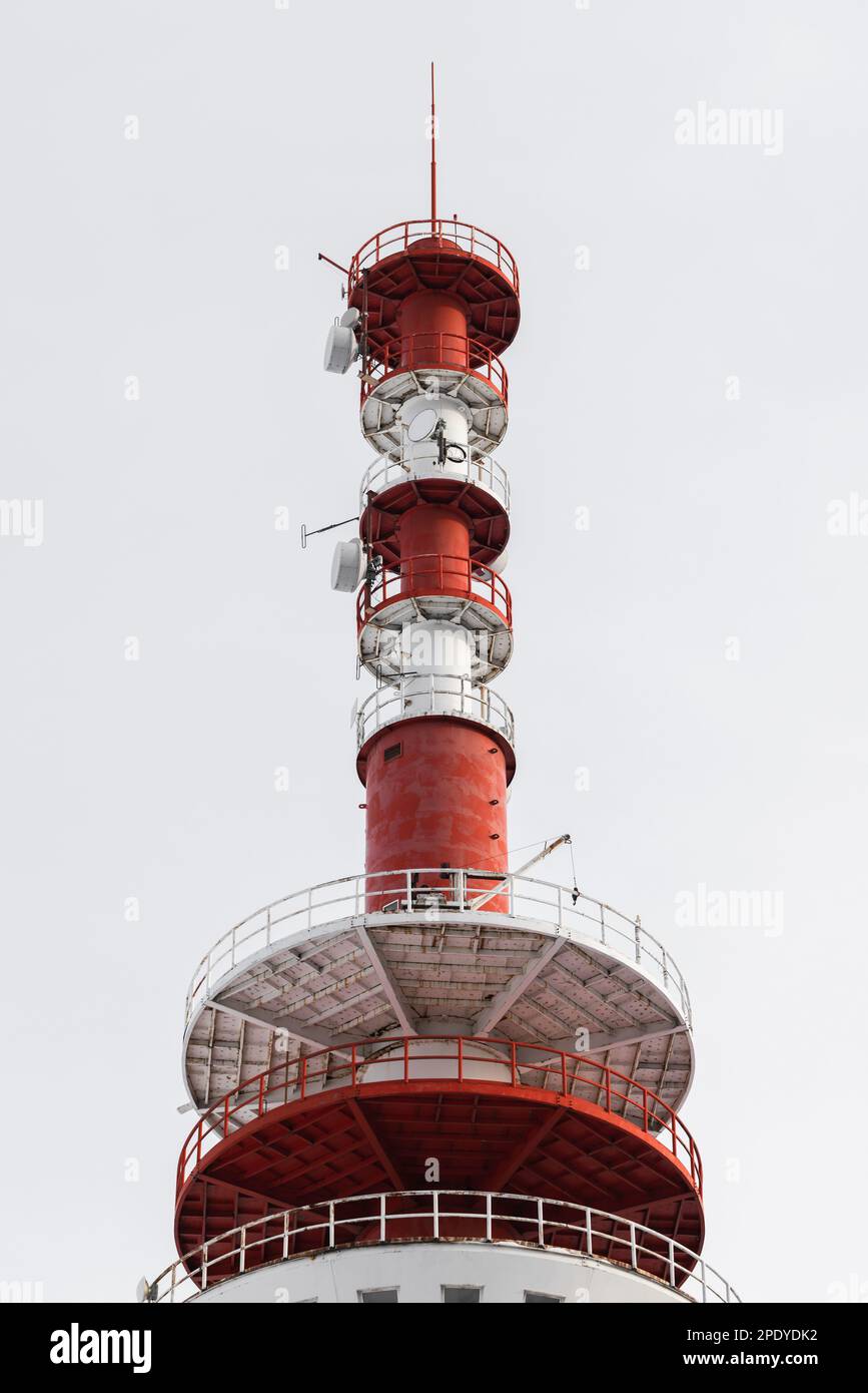 Upper part of a red white port traffic control tower with radio devices ...