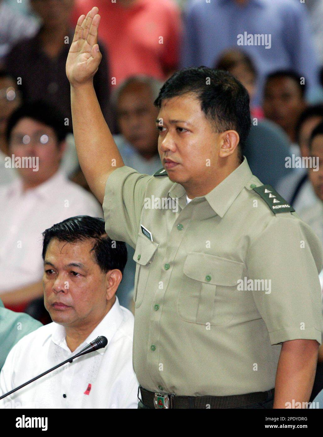 Philippine Army Captain Marlon Mendoza, right, takes his oath prior to ...