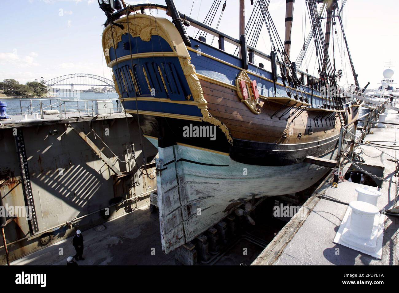 Shipwrights inspect the keel of the Endeavour replica while in drydock ...