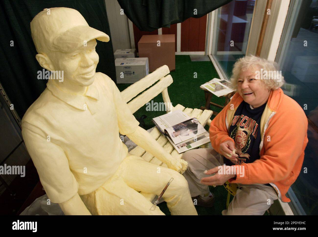 Norma "Duffy" Lyon works on a butter sculpture of golfer Tiger Woods ...