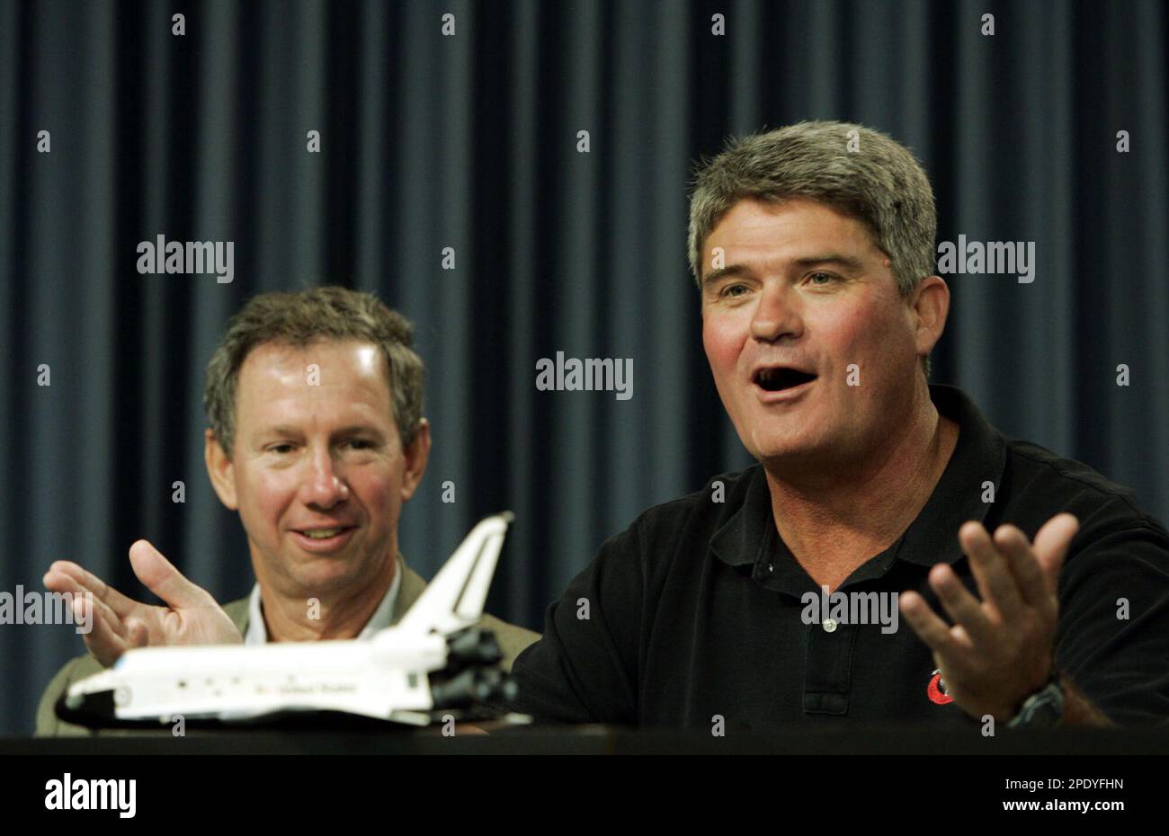 Mike Leinbach, right, Shuttle Program Manager, gestures during the post ...
