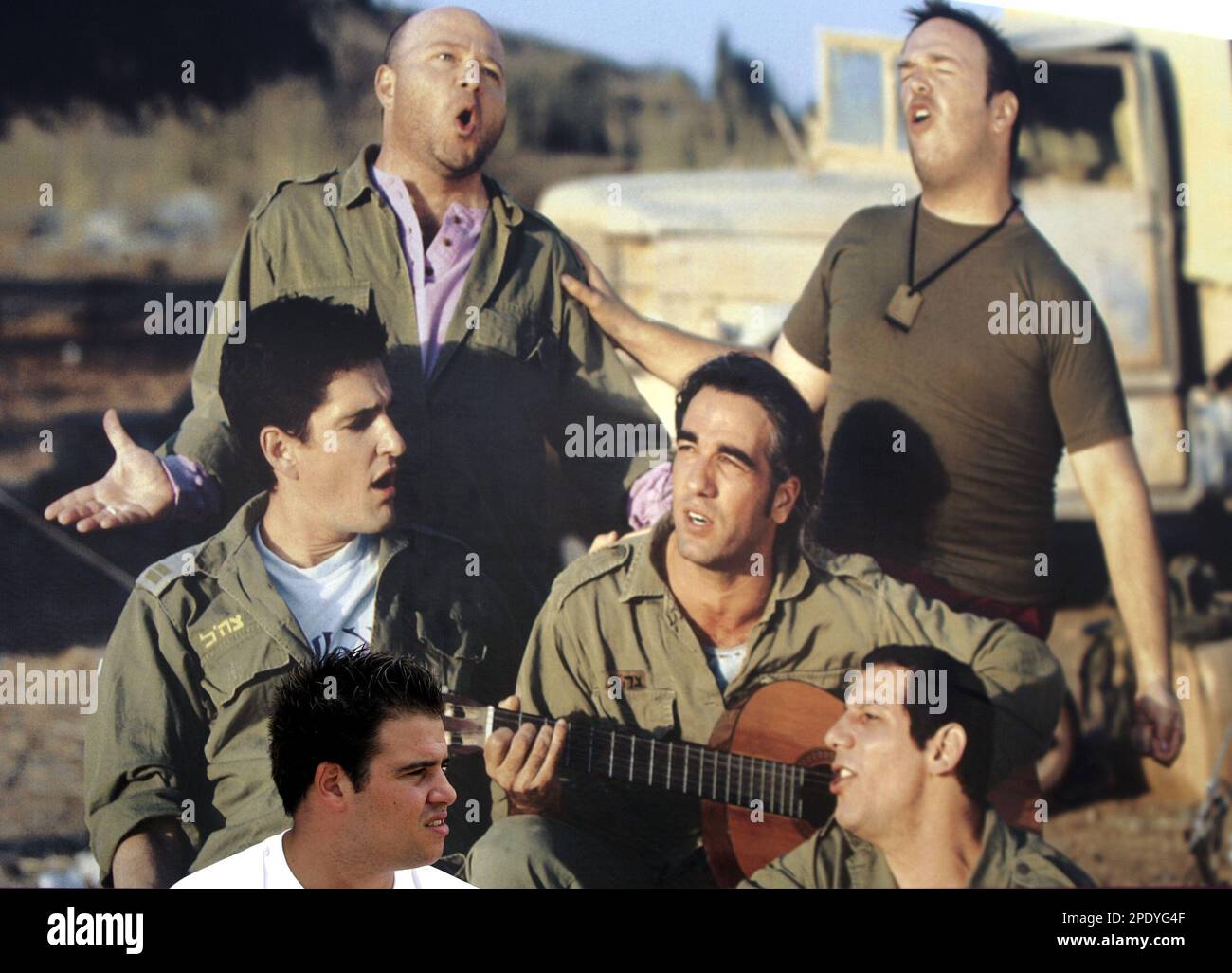 Backdropped by a poster showing Israeli army reservists singing, a ...