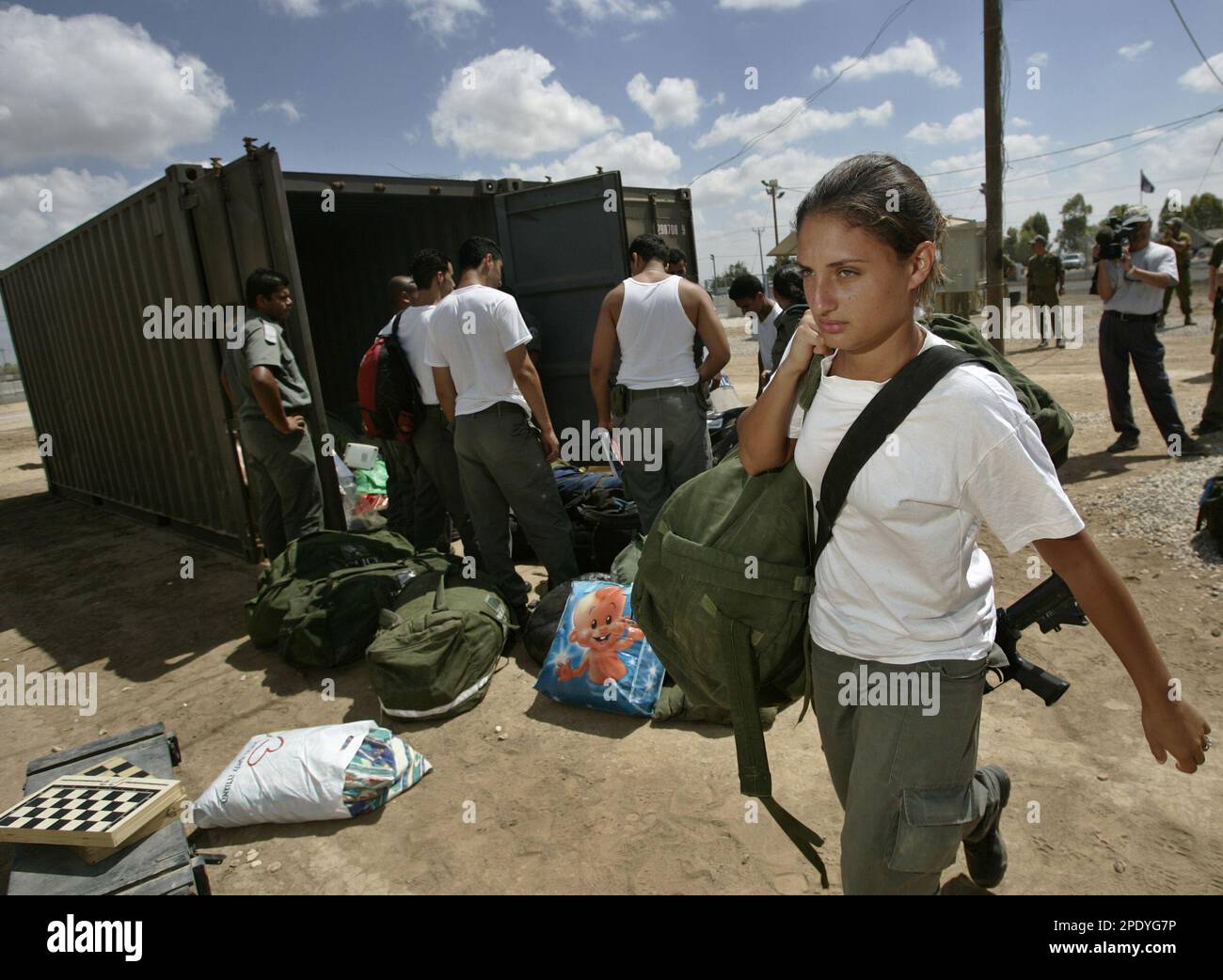Israeli border police officers unload their personal belongings from a ...