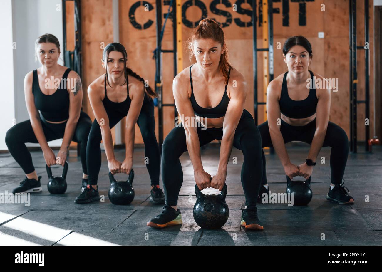 Lifting of heavy weights. Group of young sportive people have crossfit ...