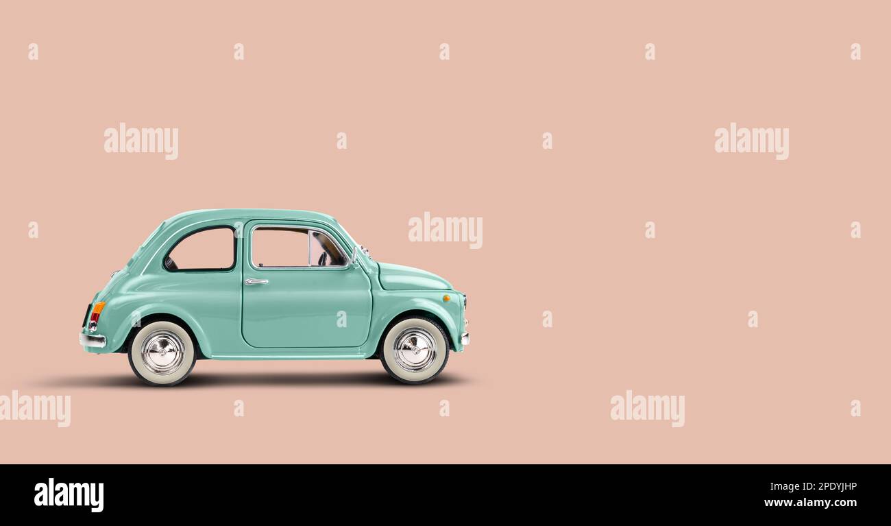 Miniature retro toy car on coral pink background with copyspace Stock ...