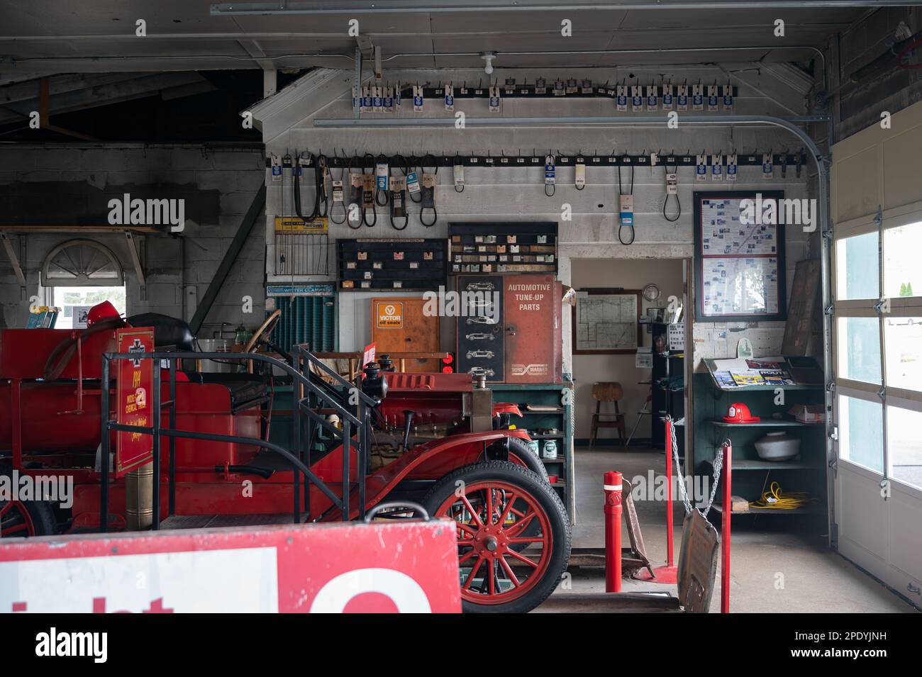 Three fire engines are parked inside a large, well-equipped garage ...