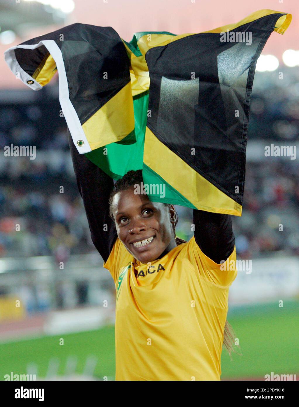 Trecia Smith of Jamaica waves her national flag after she won the Women ...