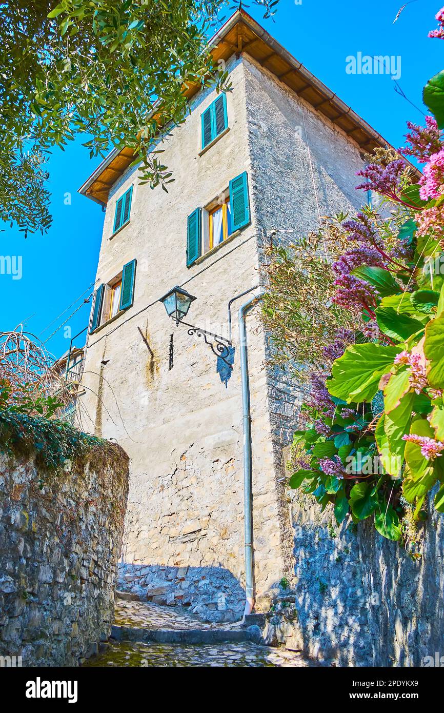 The narrow alley leads up the slope along the medieval houses of ...