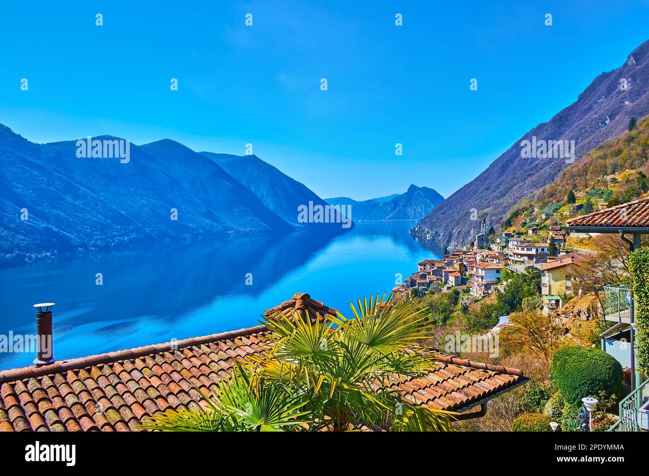 The outstanding Alpine landscape with Lake Lugano and mountain slopes ...