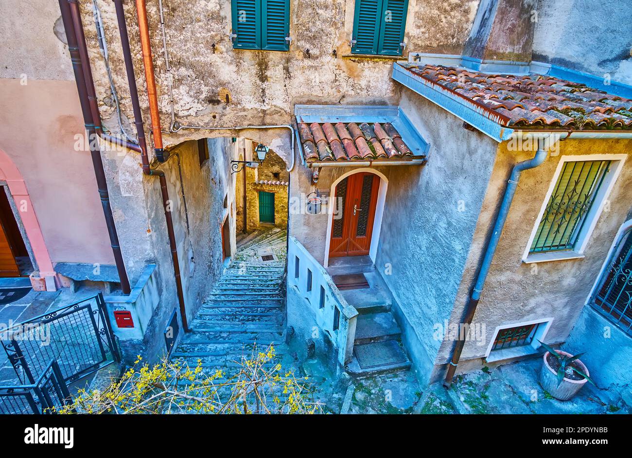 The top view of the narrow medieval descent with a stairway under the ...