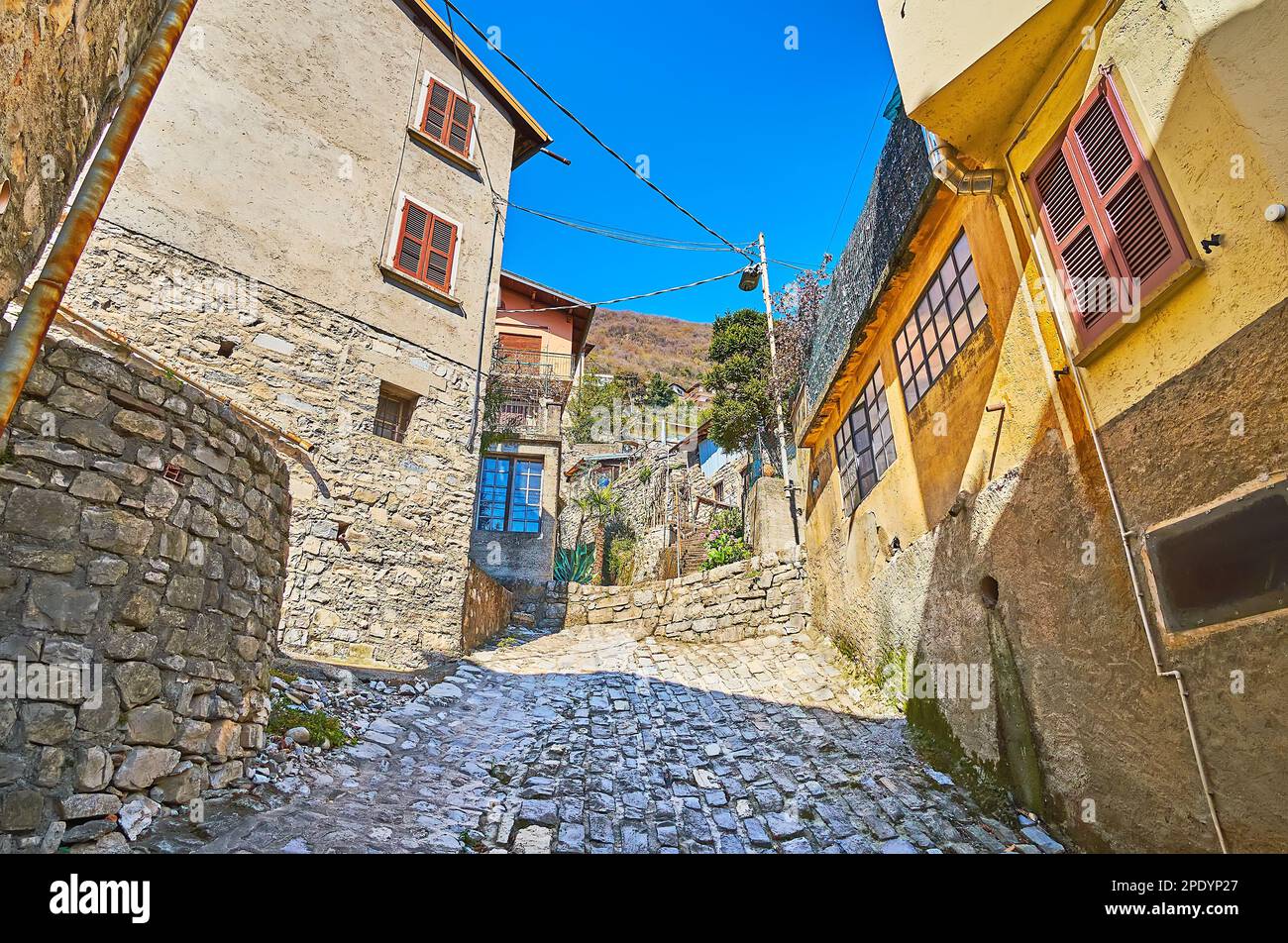 The stone descent in old Albogasio, lined with residential houses ...