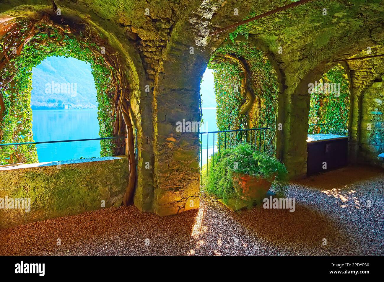 The medieval stone passage with arched windows, facing Lake Lugano ...