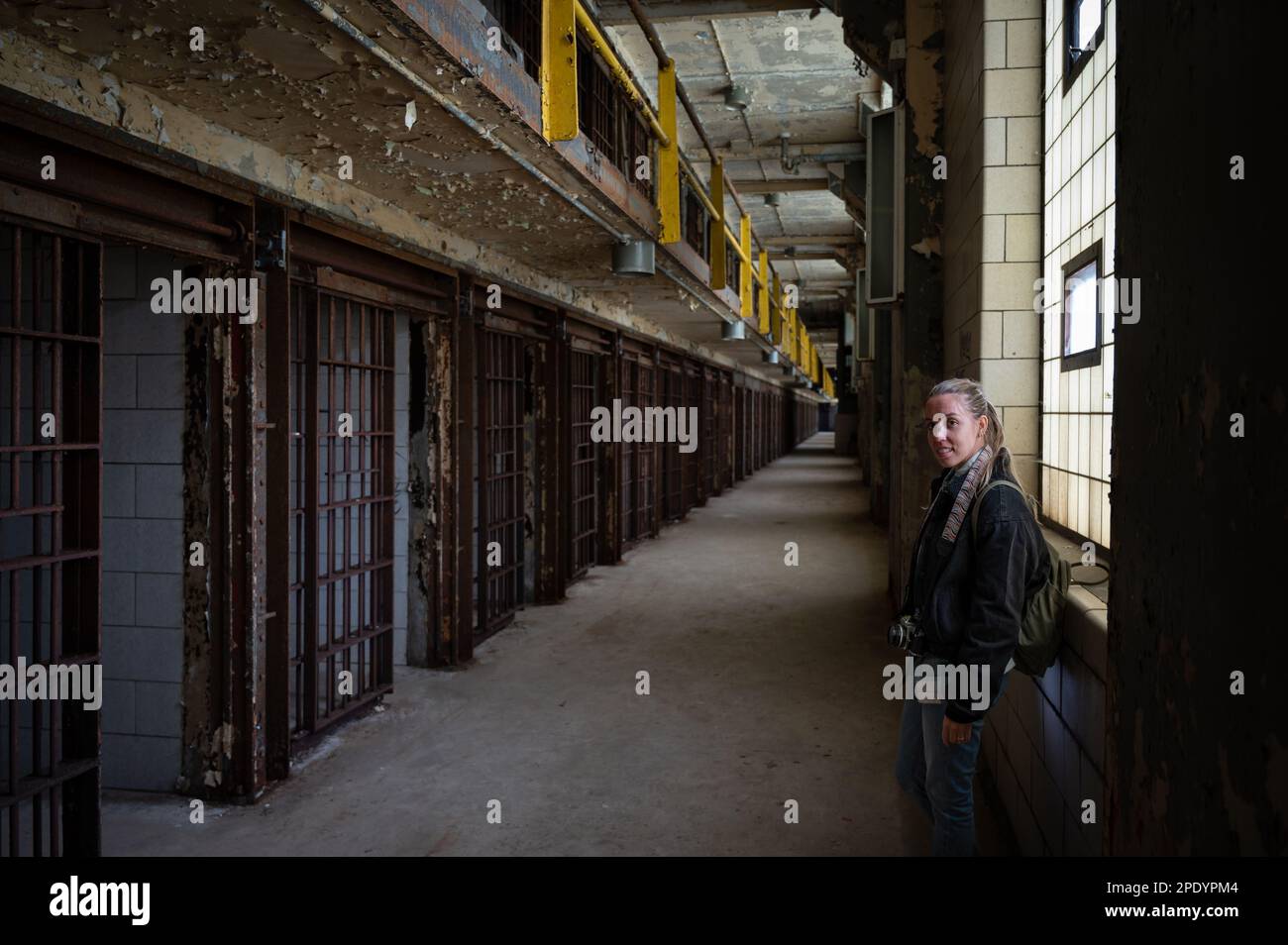 Smiling young girl visiting the cell galleries of the Old Joliet Prison ...