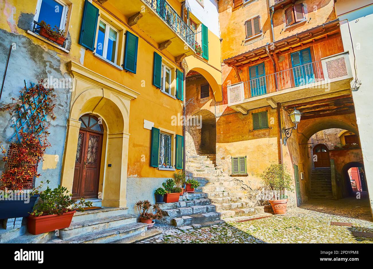 The old architecture of Oria with colored house walls, green plants in ...